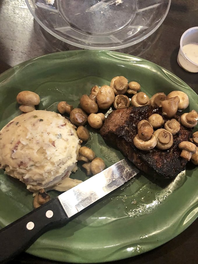 This filet mignon surrounded by mushrooms represents everything right about American steakhouse dining &ndash; pure, unapologetic indulgence at its finest.