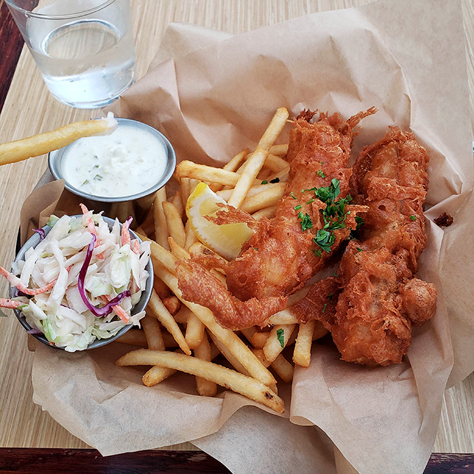 Fish and chips done right&mdash;crispy, golden batter protecting flaky white fish, with fries and slaw that aren't afterthoughts but essential supporting characters.
