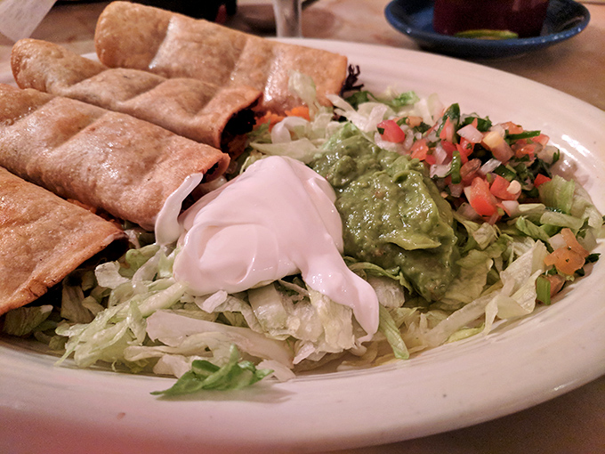 Flautas lined up like delicious soldiers, standing at attention with guacamole and sour cream ready for deployment to your taste buds.