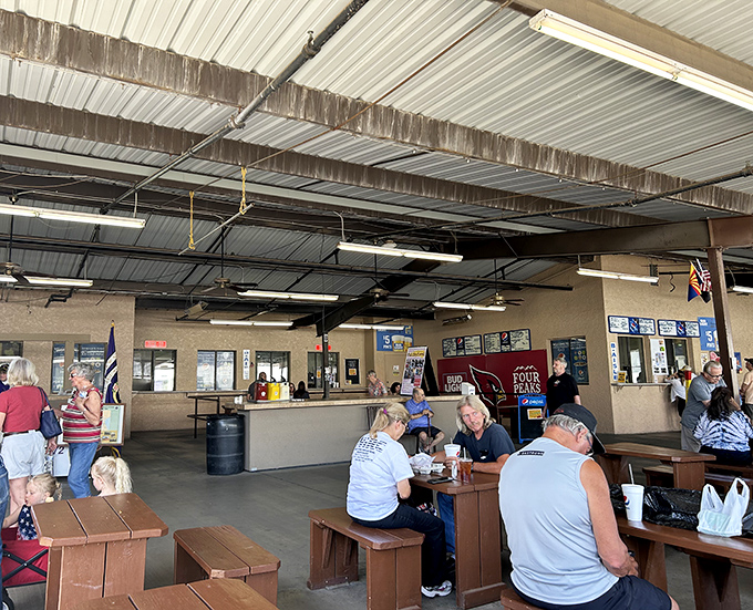 The market's food court – where shopping stamina is restored and strangers become temporary dining companions over shared tables and stories.