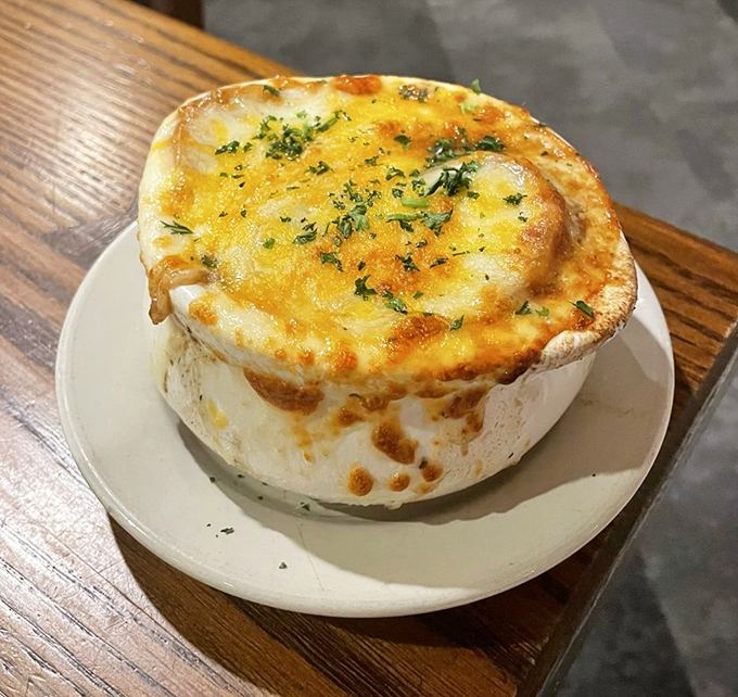 This isn't just French onion soup&mdash;it's a cheese-crowned masterpiece. Breaking through that golden dome feels like discovering buried treasure. 
