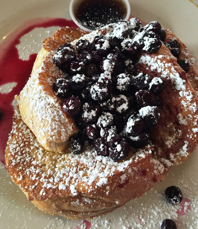 French toast elevated to art form&mdash;those blueberries aren't just toppings, they're the crown jewels in this breakfast kingdom of powdered sugar snow.