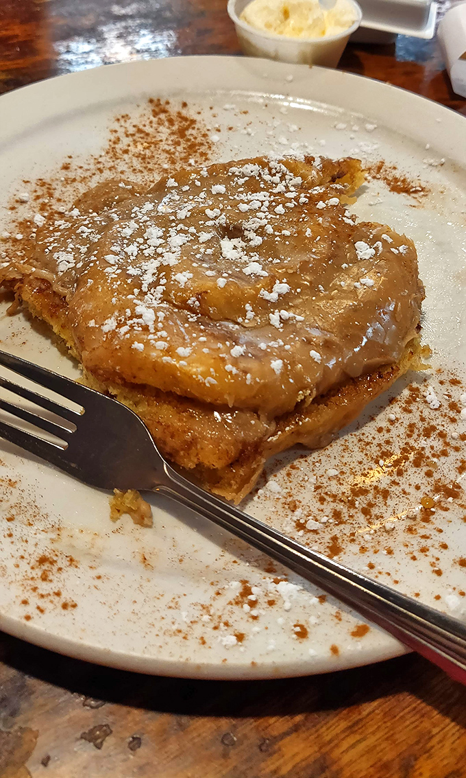 French toast that's having an identity crisis as dessert &ndash; cinnamon-dusted, powdered sugar-crowned, and utterly irresistible.