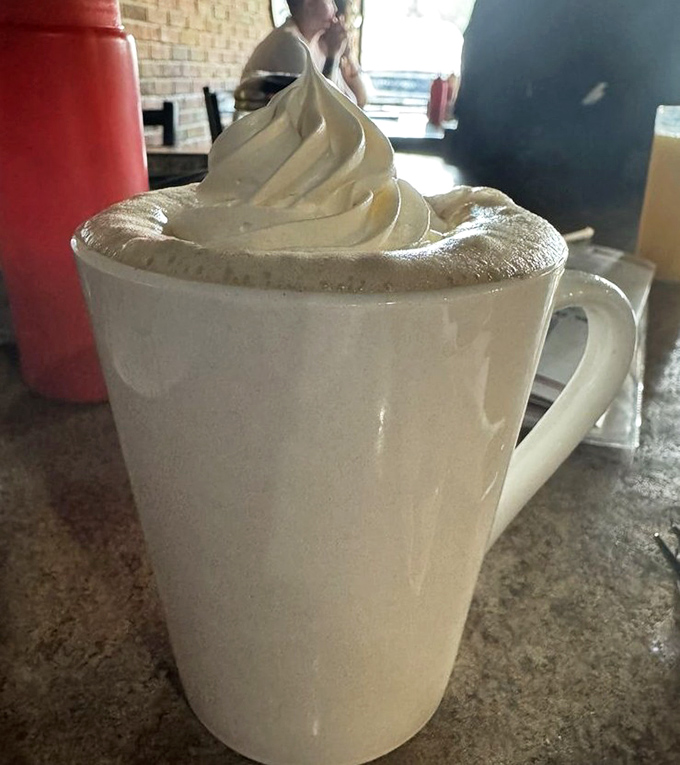 That's not just coffee&mdash;that's a cloud-topped cup of possibility. The whipped cream peak is practically begging for an alpinist's flag.