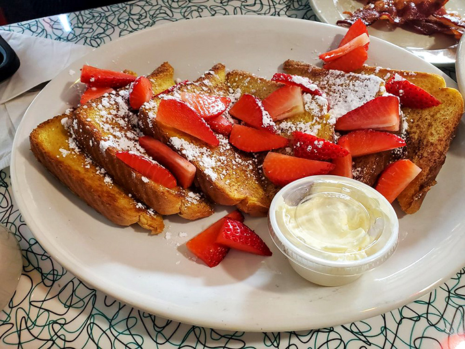 French toast that makes ordinary bread feel inadequate. Those strawberries aren't just garnish&mdash;they're jewelry for a breakfast worthy of royalty.