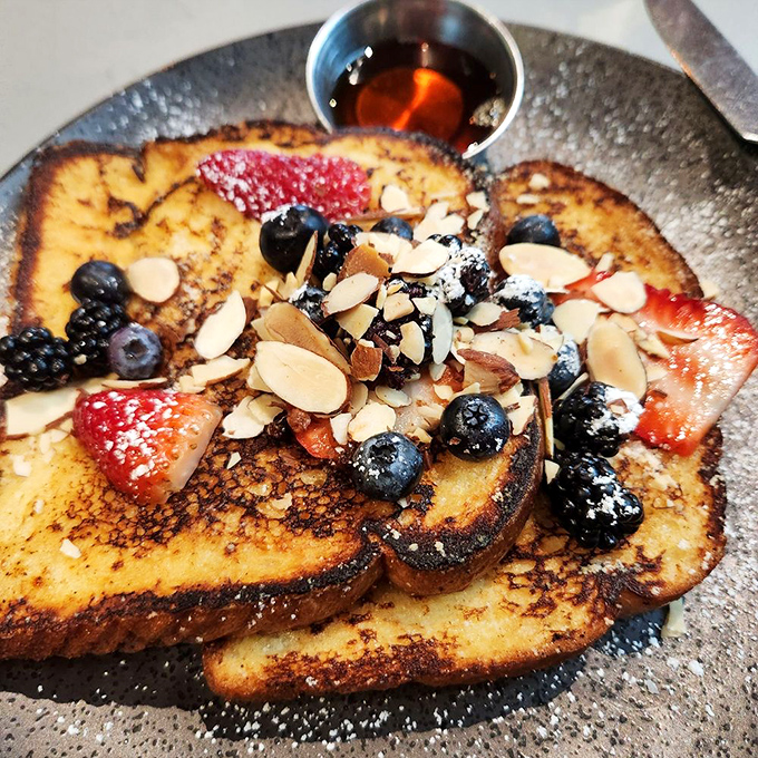 French toast that's dressed for success, wearing berries and almonds like jewelry at the breakfast ball.