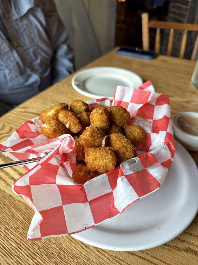 Golden-fried cheese curds nestled in a checkered basket&mdash;crispy on the outside, melty on the inside, and gone in sixty seconds.