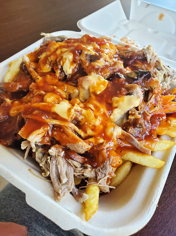 Pulled pork fries smothered in cheese and sauce&mdash;because sometimes your inner child and sophisticated adult palate need to high-five each other.