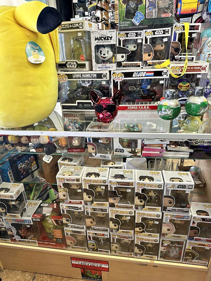 Funko Pop figures stand at attention behind glass, a plastic army of pop culture waiting for their forever homes.