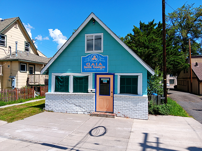 The bright blue GAIA building adds a splash of color to the town, looking like it belongs equally in a mountain village or a Wes Anderson film.