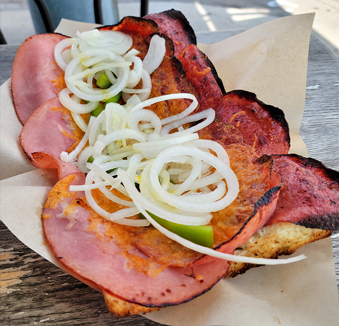 The legendary Garbage Grinder reveals its secrets: ham, onions, and enough filling to feed a small village.