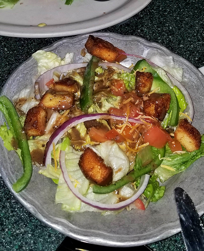 Even the garden salad gets the royal treatment, with crisp greens, vibrant veggies, and croutons that clearly didn't come from a box that's been open since last football season.