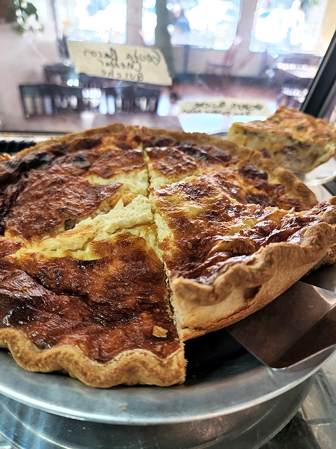 Quiche that makes you question why anyone would ever choose a sad desk lunch over this symphony of cheese and bacon.