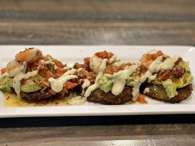 These aren't just fried green tomatoes &ndash; they're Southern tradition transformed into bite-sized treasures topped with seafood and avocado.