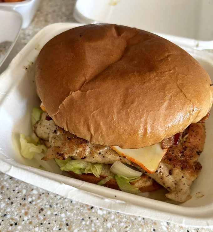 A grilled chicken sandwich that doesn't apologize for not being a burger – confident in its perfectly seasoned, char-marked identity.