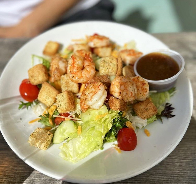 A salad that doesn't feel like punishment. Plump grilled shrimp and homemade croutons transform ordinary greens into something worth celebrating.