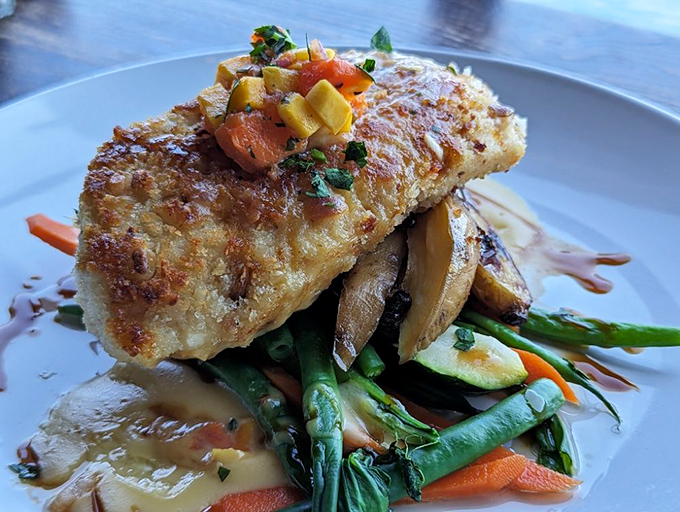 This isn't just fish&mdash;it's a perfectly crusted halibut perched atop a garden of vegetables like it's posing for a seafood magazine cover shoot.