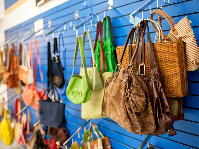 Handbag heaven on a blue wall&mdash;from practical totes to statement pieces. That woven basket bag is practically begging for a farmers market adventure.