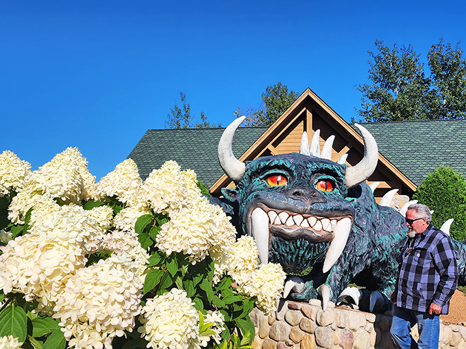 Spring blooms frame our scaly friend perfectly, proving that even monsters appreciate a little garden therapy.