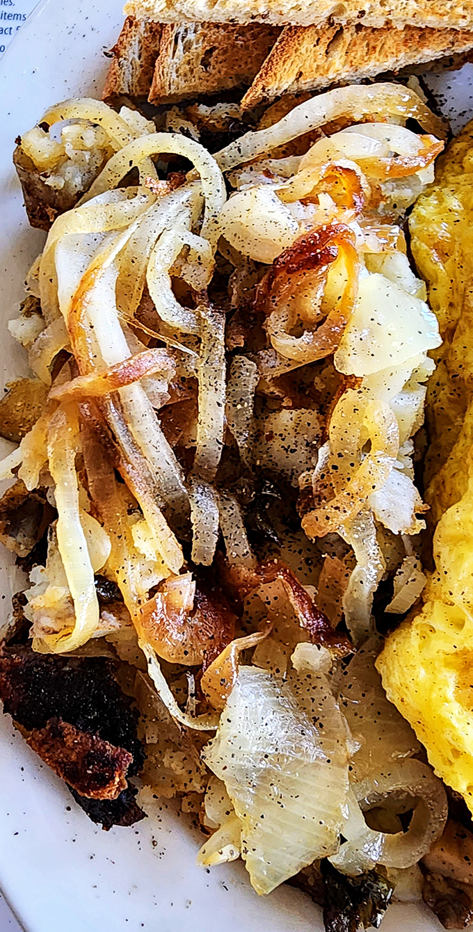Caramelized onions dancing with home fries&mdash;proof that the simplest ingredients make the most memorable supporting acts.