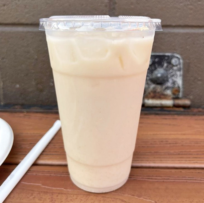 The horchata comes in a simple cup but delivers complex comfort—a sweet, cinnamon-kissed counterpoint to the savory taco experience.