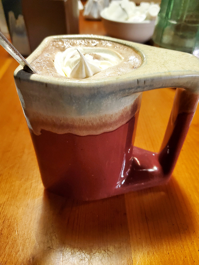 Hot chocolate that makes Swiss chocolatiers nervous. That dollop of whipped cream isn't floating &ndash; it's performing a trust fall into heaven.