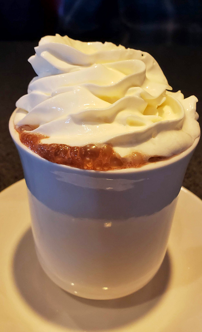 Hot chocolate topped with whipped cream towers that make you feel like a kid again.