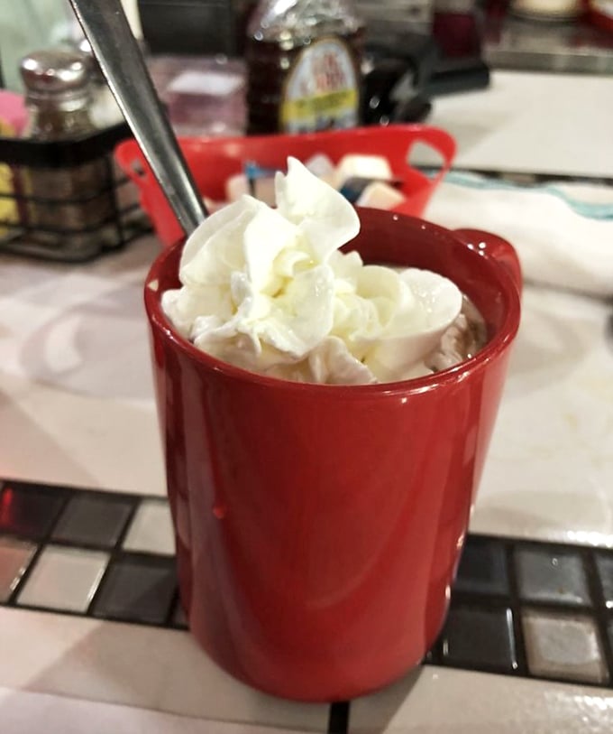 Hot chocolate that doesn't know it's in Florida &ndash; topped with a cloud of whipped cream in a mug as red as your future food cravings.