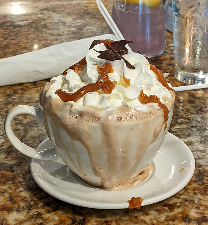 Hot chocolate that's dressed for the occasion, topped with whipped cream, caramel, and chocolate that means business.