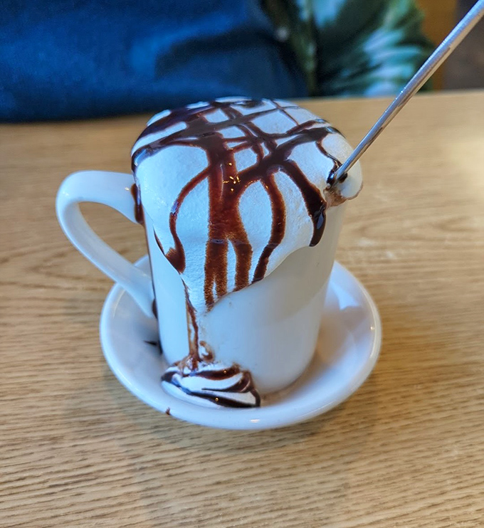 Hot chocolate that doesn't just arrive with whipped cream&mdash;it arrives with a chocolate drizzle performance art piece. This isn't a beverage; it's dessert in disguise.
