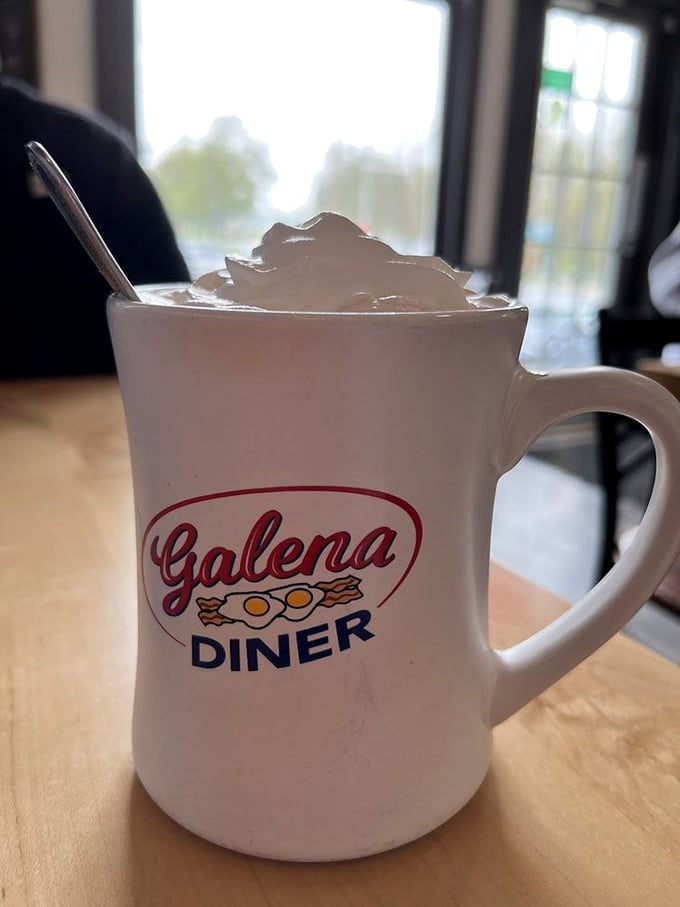 Their signature mug, topped with whipped cream mountain. Coffee tastes 37% better when served in a mug with the diner's logo.