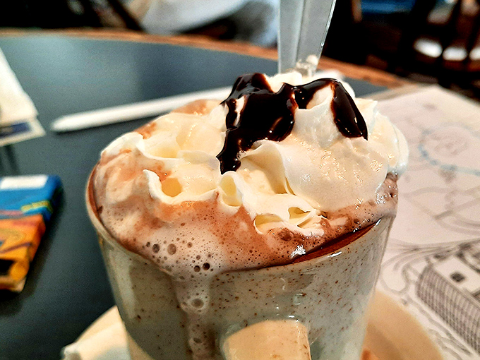 Hot chocolate that doesn't mess around – topped with a cloud of whipped cream and chocolate drizzle that would make Swiss chocolatiers jealous.