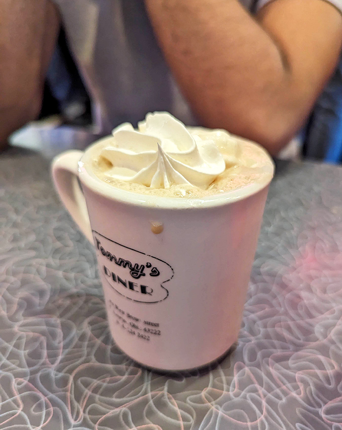Hot chocolate that remembers it's supposed to be a treat, not just warm brown water. That whipped cream mountain deserves its own zip code.
