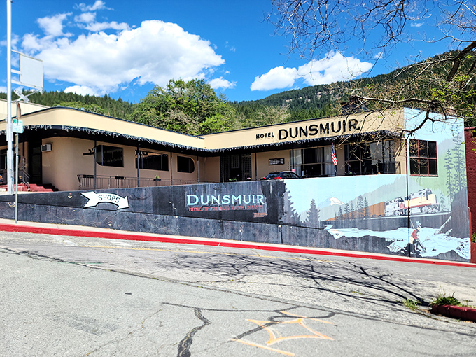 Hotel Dunsmuir stands ready for weary travelers, its vintage charm and mountain mural promising adventures that don't require scrolling or Wi-Fi.