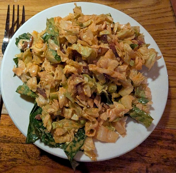 A house salad that defies the "obligatory vegetable" category, packed with enough flavor to make you temporarily forget about the steak to come.