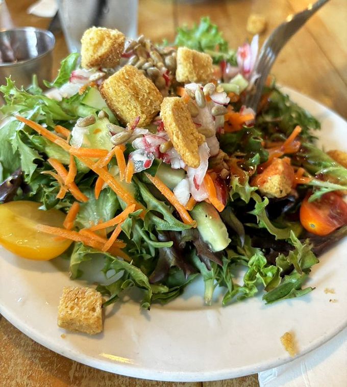 This vibrant house salad isn't just eating your vegetables &ndash; it's a colorful garden party with crunchy croutons playing the role of welcome guests.