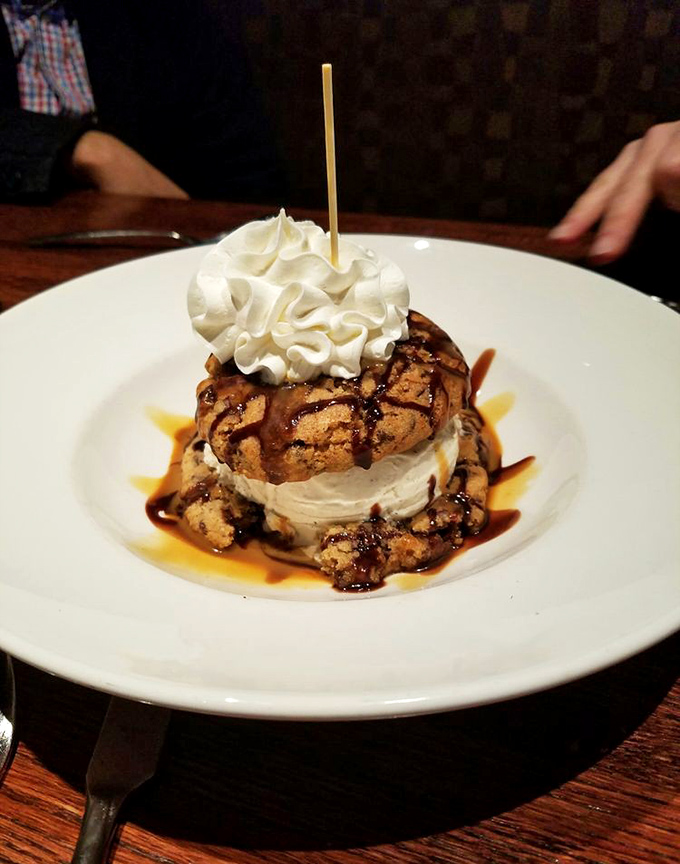 Dessert architecture at its finest. This towering ice cream sandwich creation proves that sometimes the best things in life come with whipped cream and caramel drizzles.