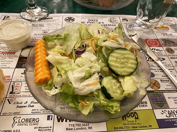 Even the humble house salad gets the royal treatment, with crisp vegetables and that signature supper club presentation that says, "Save room for what's coming next!"