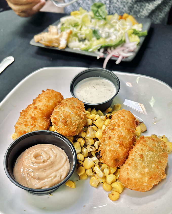 These golden-fried treasures nestled on roasted corn with dipping sauces are the appetizer equivalent of finding money in your old jacket pocket.
