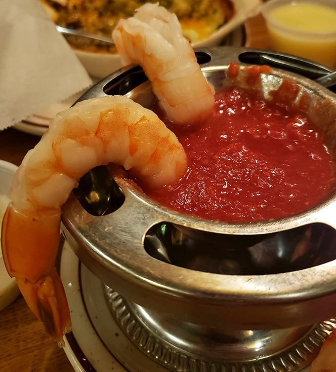 These jumbo shrimp are hanging on the edge of their silver chalice, practically begging you to dunk them in that zesty cocktail sauce.