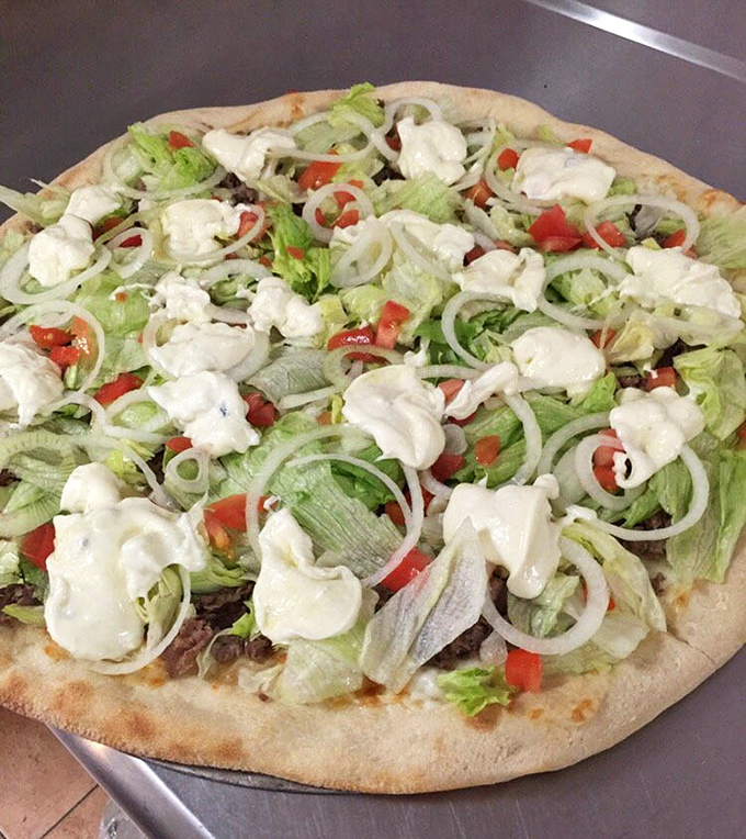 Fresh veggies and cheese create a garden party on this pizza. Proof that eating your vegetables can be a joyous occasion.