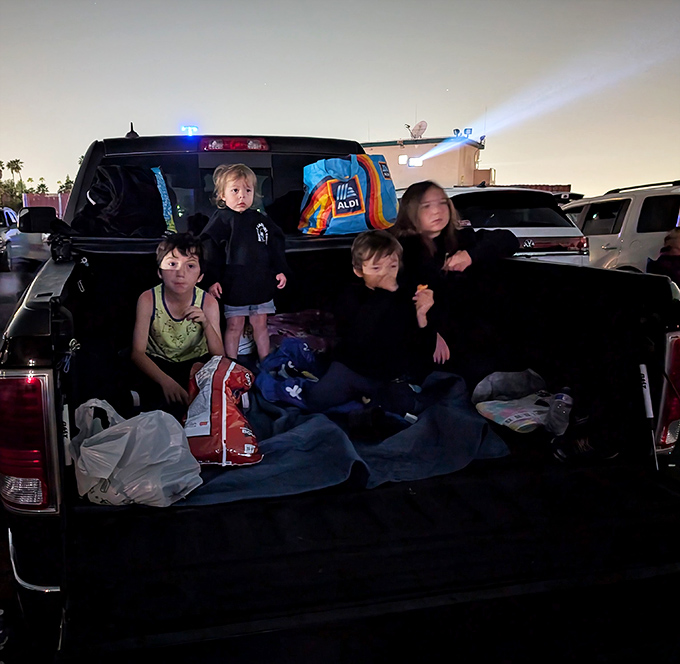 Family movie night reimagined&mdash;kids claiming territory in pickup beds with blankets and snacks, creating memories that'll outlast any streaming subscription.