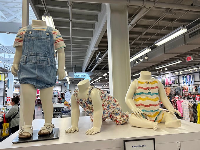 Children's mannequins caught in playful poses showcase adorable overalls and striped outfits that make you wish they came in adult sizes too.