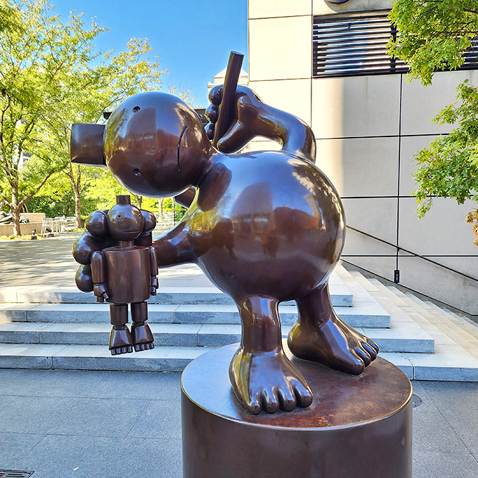 Tom Otterness's "Kindly Geppetto" brings storybook charm to downtown, looking like he just stepped out of a fairy tale to enjoy city life.