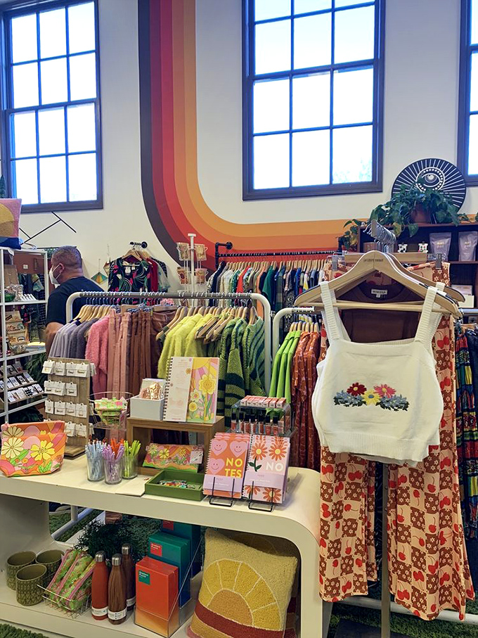 A rainbow wall provides the perfect backdrop for this clothing display, where vintage-inspired fashion and handmade accessories create a color story.
