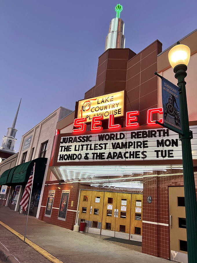 The Select Theater's neon marquee glows like a beacon of nostalgia, advertising first-run films at prices that won't require a second mortgage.