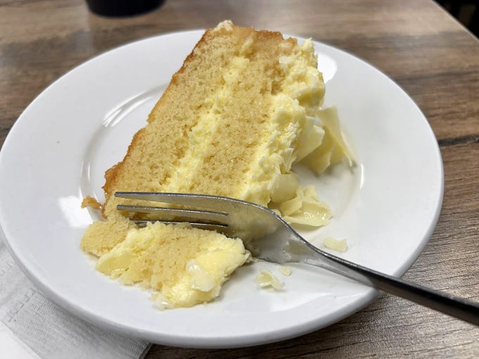 A slice of cake so light and fluffy it practically floats off the plate. Dessert isn't optional here&mdash;it's the final movement in a soul food symphony.