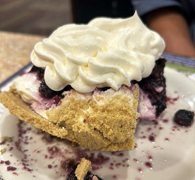 This lemon blueberry pie wears its whipped cream crown like royalty, and rightfully so.