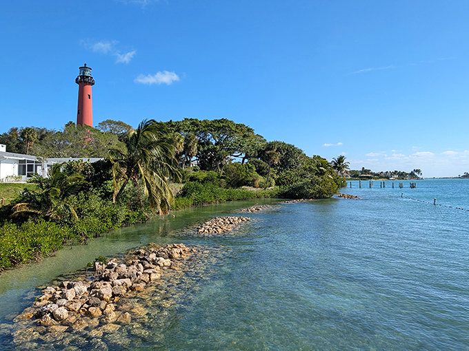 Where turquoise waters meet emerald landscapes, the lighthouse stands as Jupiter's exclamation point&mdash;a splash of vibrant history against paradise.