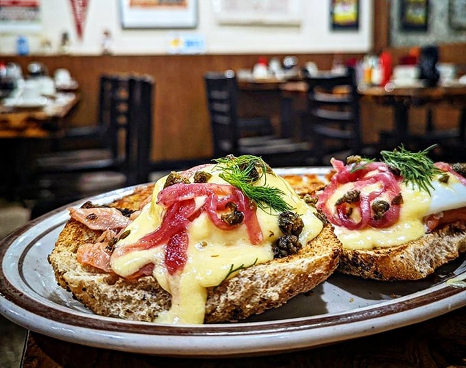 The Lox Benedict elevates breakfast with silky smoked salmon, vibrant pickled onions, and capers atop crusty bread &ndash; a symphony of flavors that dance across your palate.